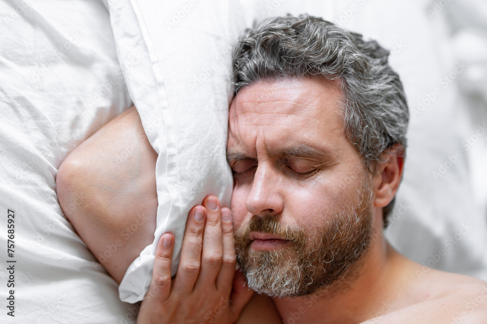 Man sleeping in bed. Top view of handsome man sleeping in bed. Morning ...