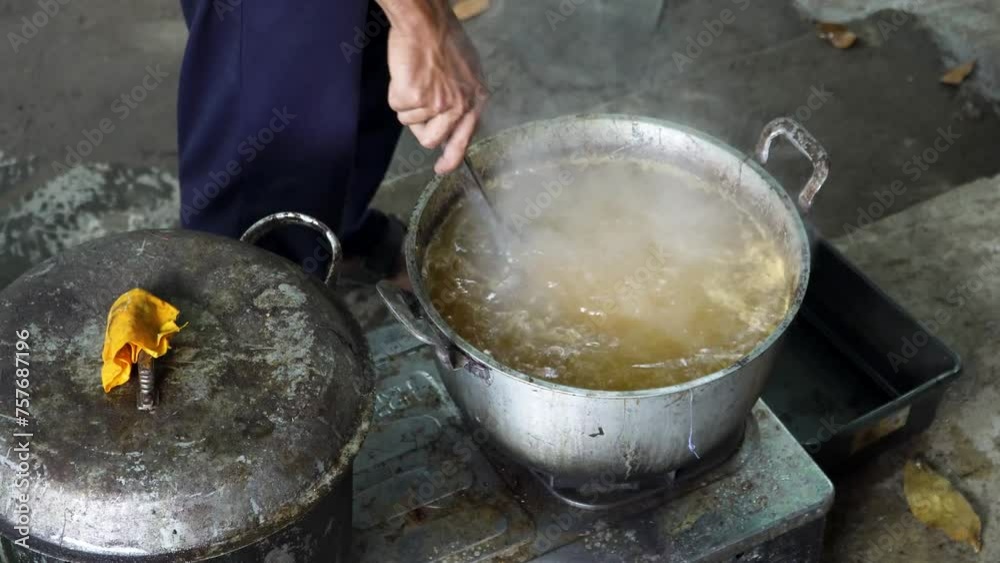 4k close up footage of students' hands dyeing traditional batik cloth ...