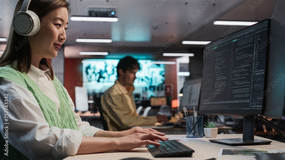 Female Asian Game Programmer Coding On Desktop Computer In Game ...