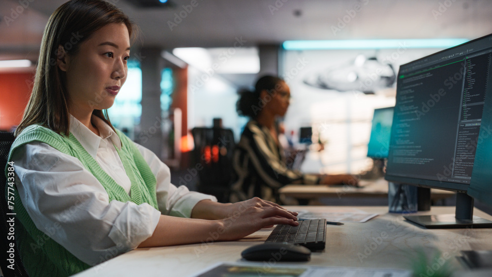 Female Asian Game Programmer Coding On Desktop Computer In Game Development Studio Diverse ...