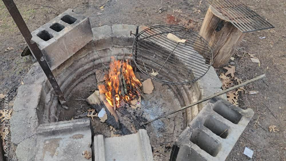 Top view of wood being burn in deep fire pit made from truck tire rim ...