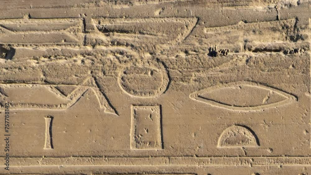 Ancient Egyptian hieroglyphs and bas-reliefs close-up in Luxor Temple ...