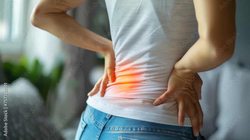 woman holding her lower back while and suffer from unbearable pain ...