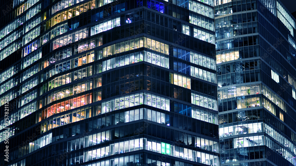Office building at night, building facade with glass and lights. View ...