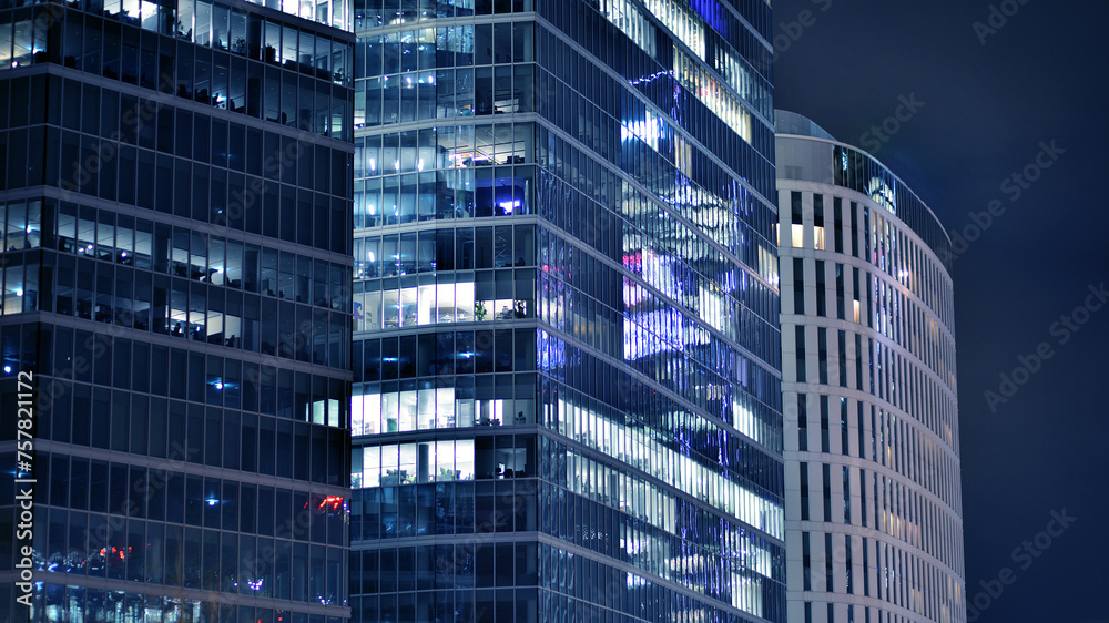 Office building at night, building facade with glass and lights. View ...