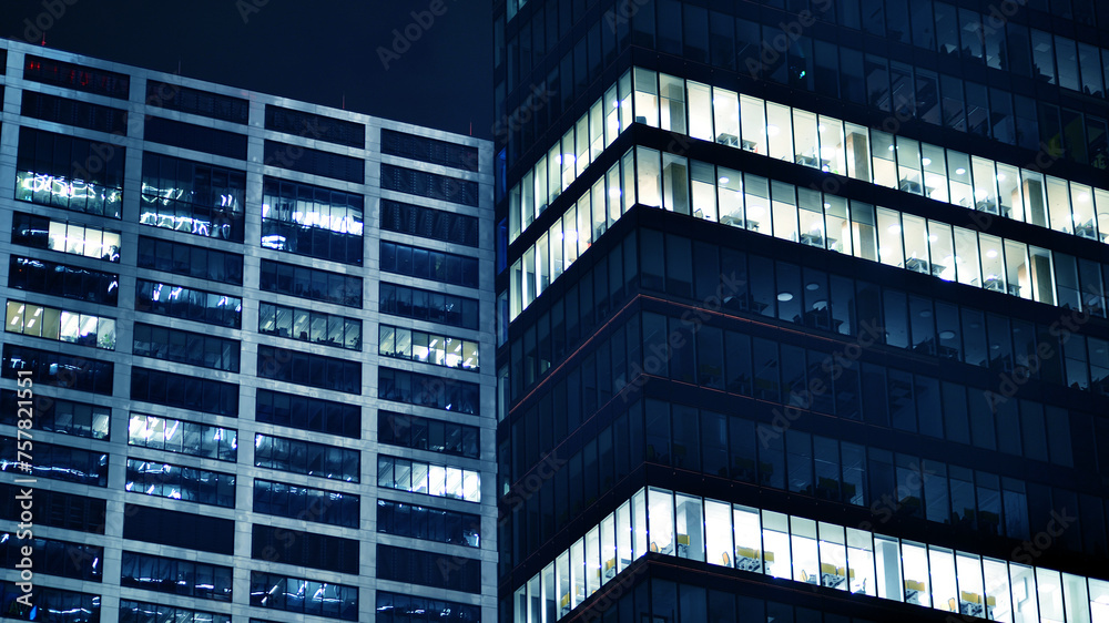 Office building at night, building facade with glass and lights. View ...