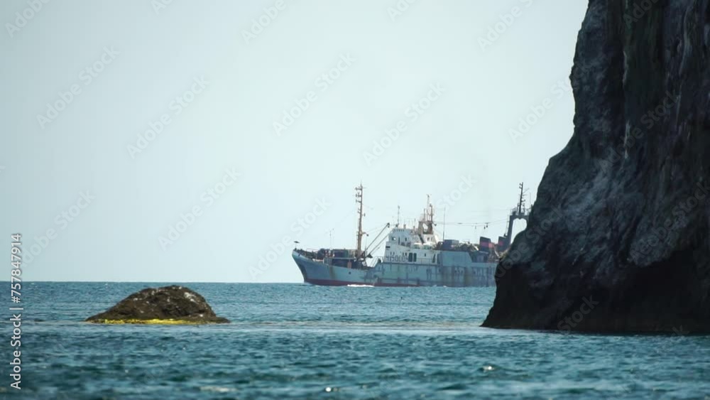 Fishing boat trawler catches fish while sailing on sea. A commercial ...