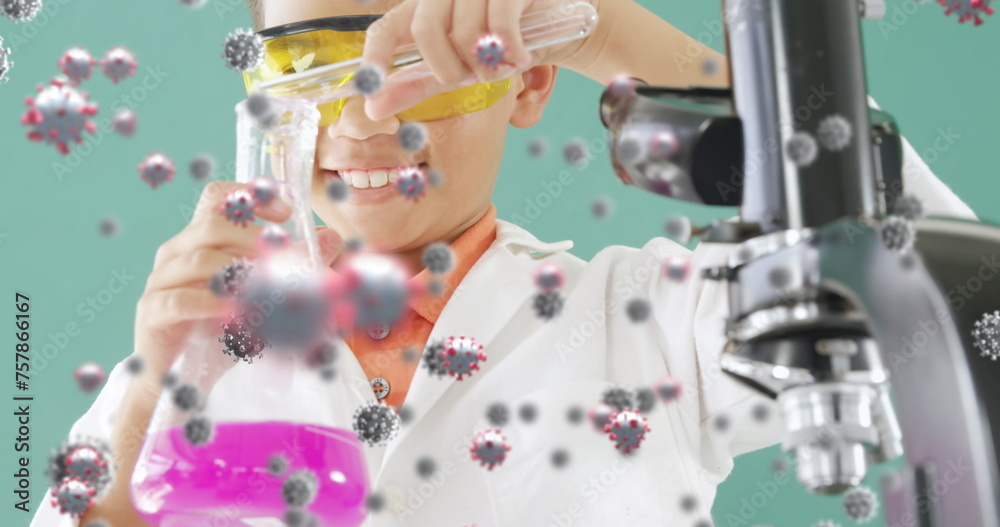 Image of coronavirus cells flowing over a view of male student using ...