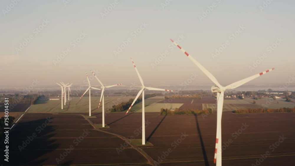 Cinematic drone shot wind turbine farm during sunset or sunrise ...