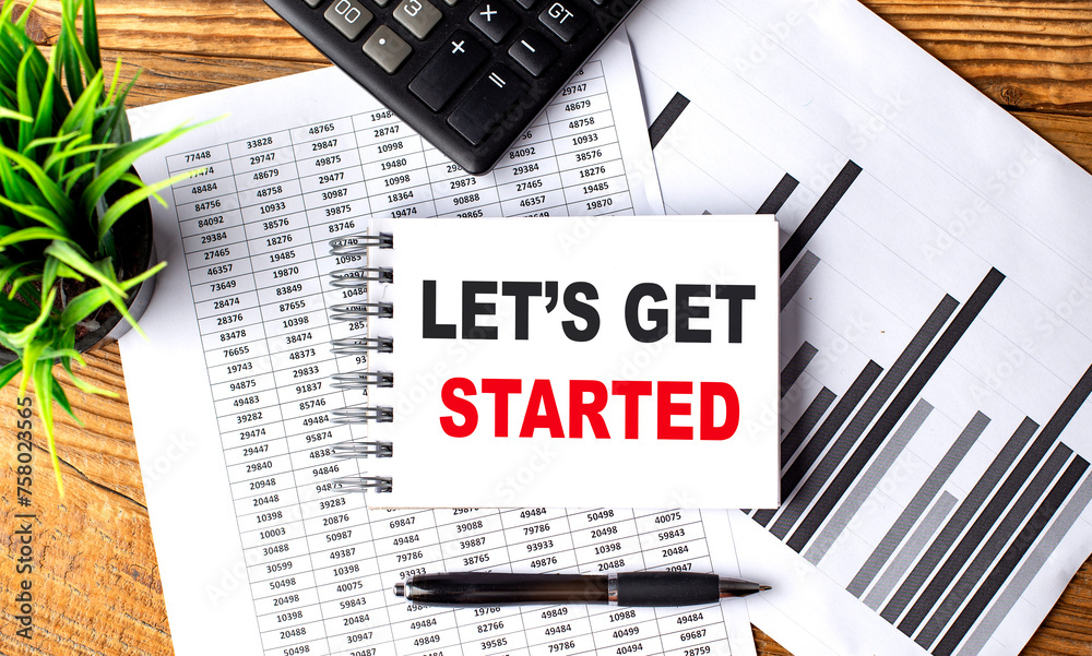 LET'S GET STARTED text on a notebook with chart and calculator Stock ...