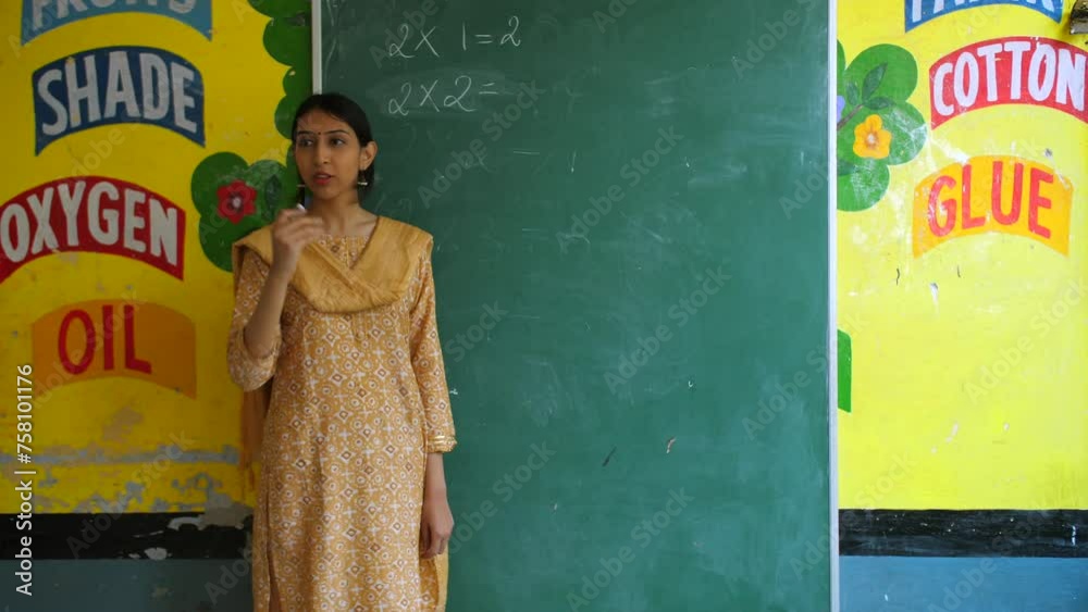 Vidéo Stock Female Indian teacher teaching basic multiplication to ...