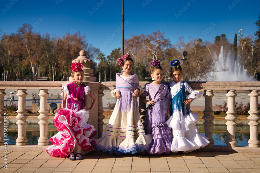 four pretty little girls dancing flamenco dressed in typical gypsy ...