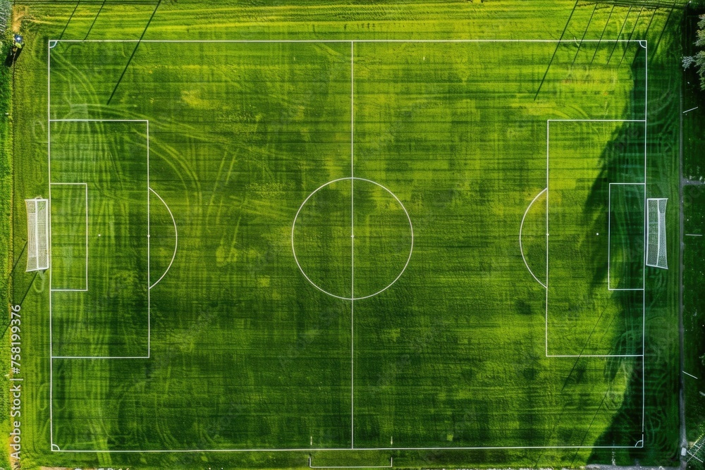 an aerial view of a vibrant green soccer field, showing the lines ...
