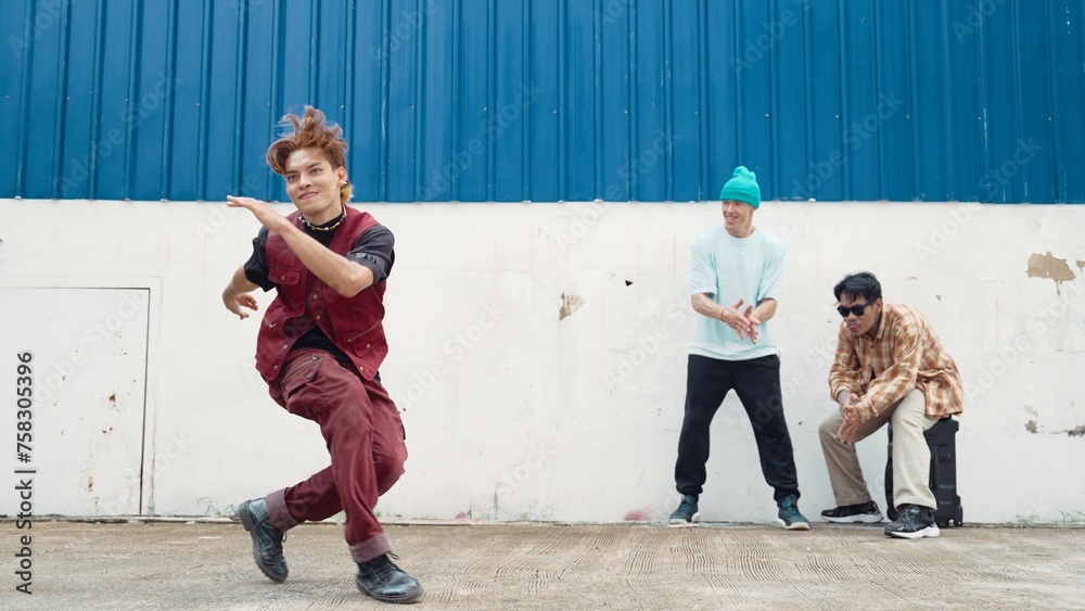 Young street dancer dancing in hip hop style with multicultural friends ...