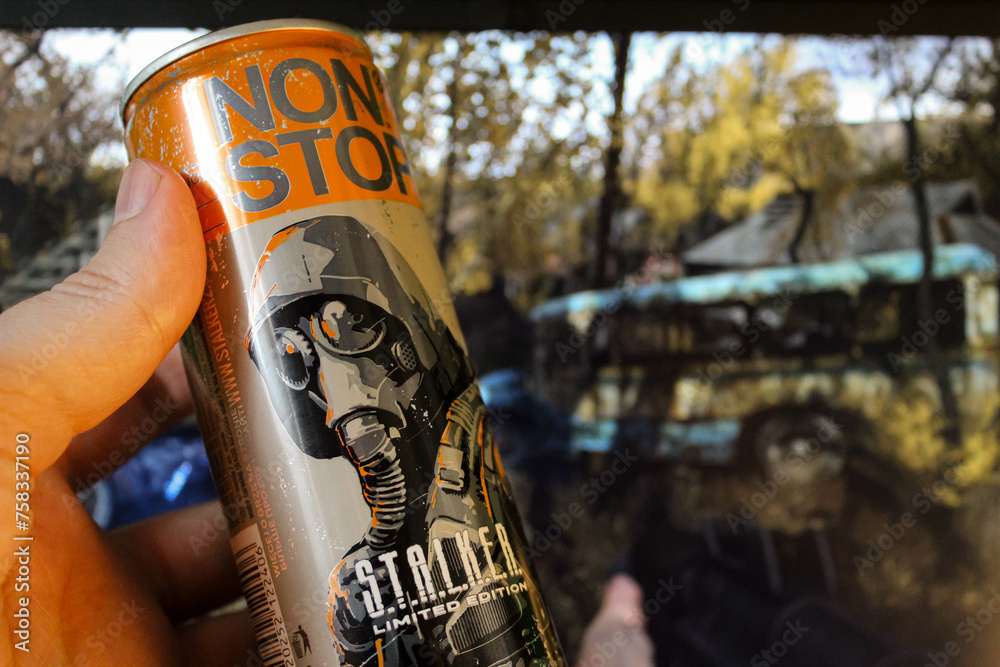 Stalker holds an energy drink Non-stop with an image of a stalker in a ...