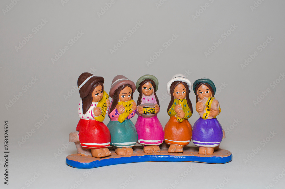 Peruvian handicraft in grey background. Five women musicians playing ...