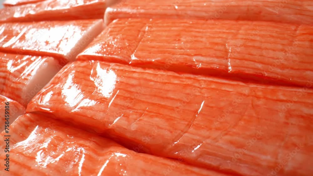 A close-up of crab sticks reveals their imitation crabmeat texture ...