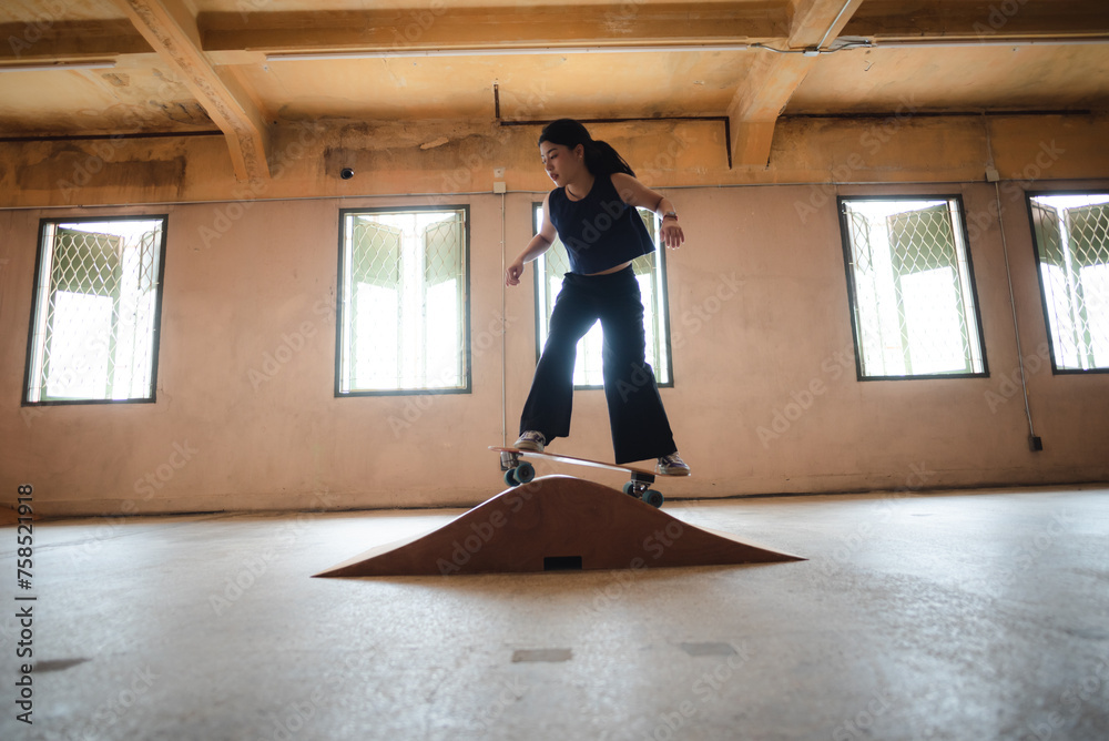 skater woman person playing skateboard in sport gym, young Asian woman ...