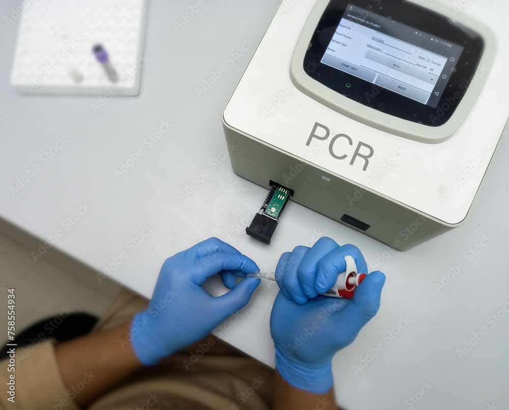 Scientist pipetting sample for PCR test at PCR machine. pipette into ...