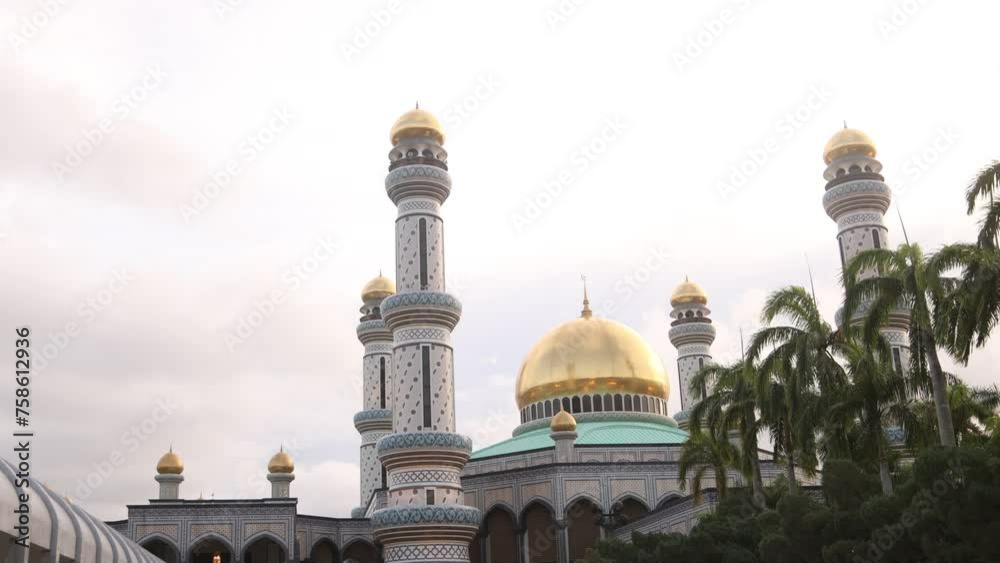 golden dome of mosque above tropical palm trees at Jame' Asr Hassanil ...