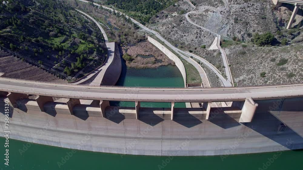 Dam spillway. Gravity dam and water reservoir. Dolly in aerial view of ...