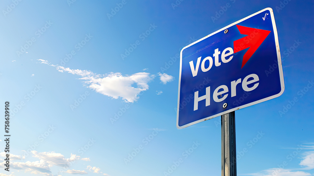 A blue Vote Here sign with a red arrow under a clear sky with fluffy ...