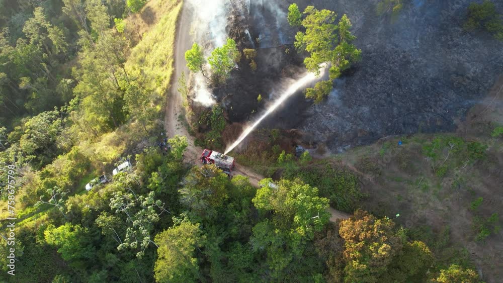Firefighter extinguishing forest fire on mountain in tropical landscape - Dangerous Fumes and ...
