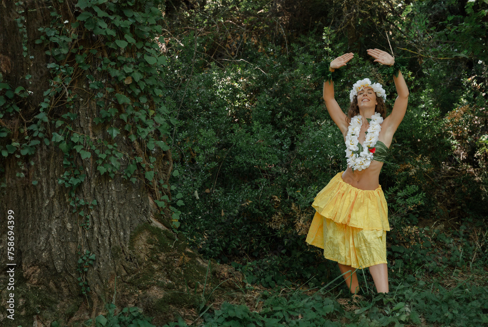 Young dancer performing Tahitian dance in the natural habitat of the ...