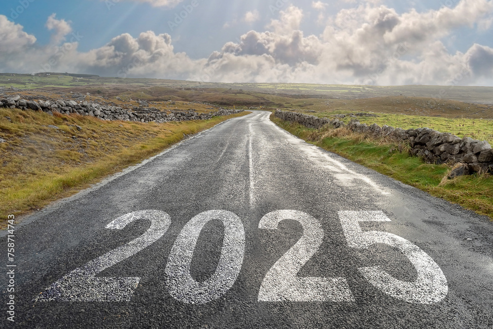 Sign 2025 on asphalt road in a beautiful country setting with dramatic ...