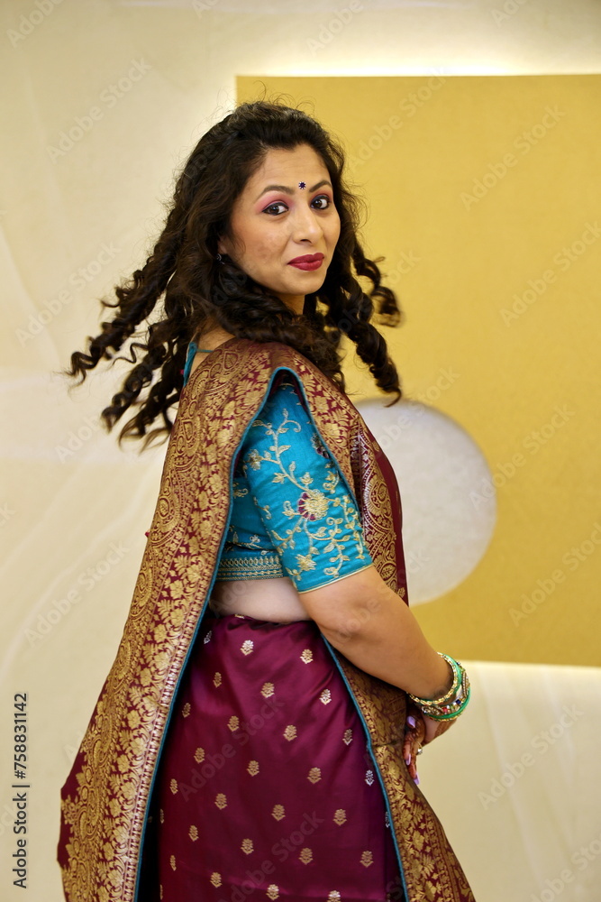 Gujarati woman wearing Saari in Gujarati stlye. Model is posing with a ...