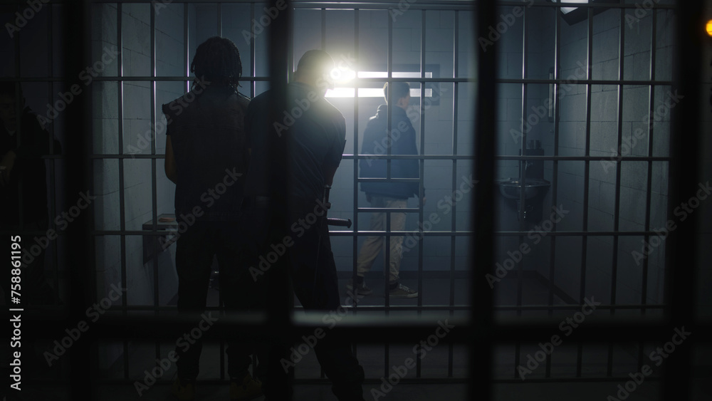 Warden brings new prisoner in jail cell and takes off his handcuffs ...