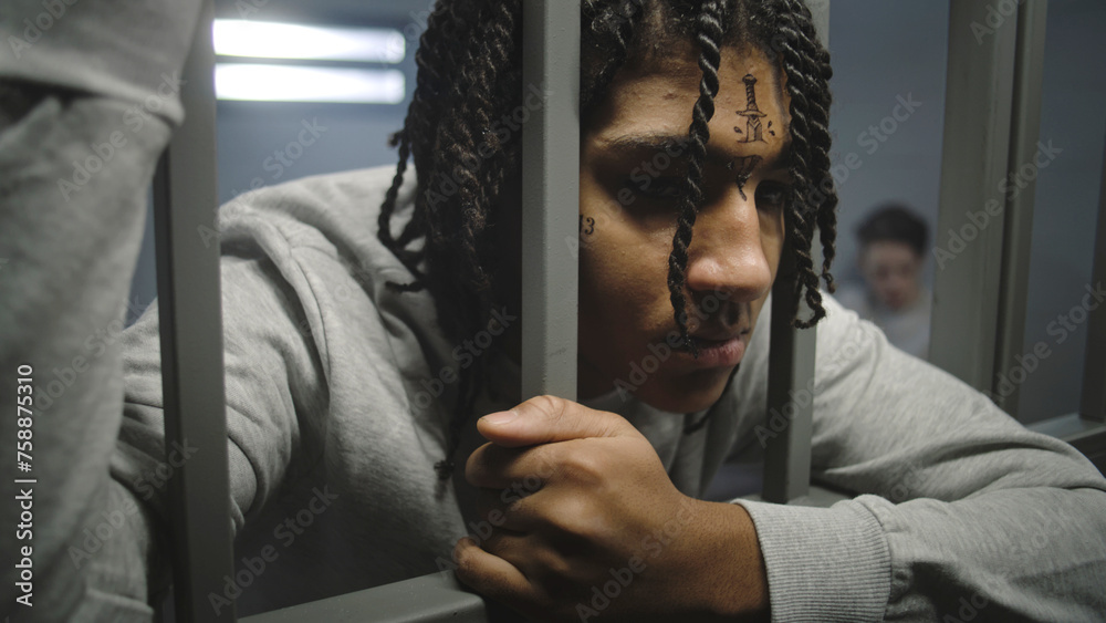 Close up shot of angry African American teenage prisoner with face ...