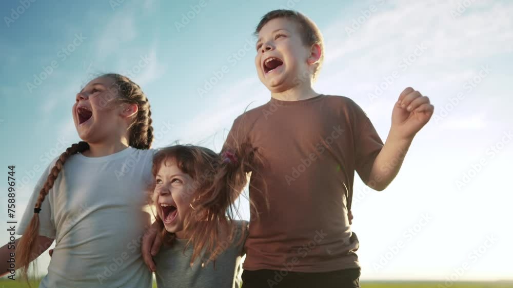 group of kids team hugging jumping and rejoicing outdoors. happy family ...