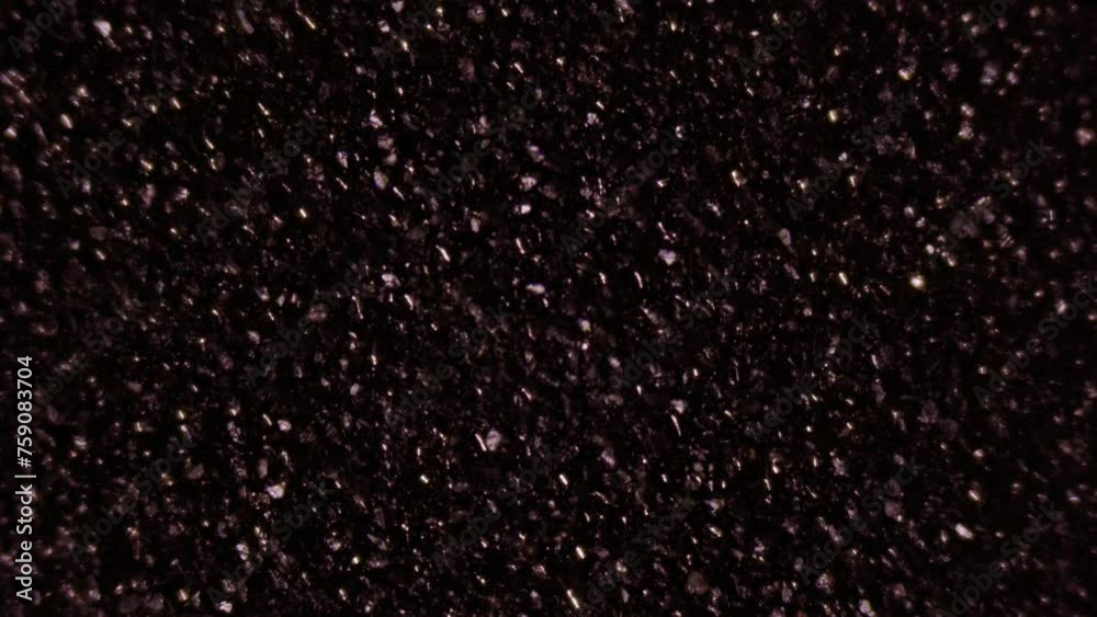 Microscopic artificial crystals sparkle under microscope in dark ...