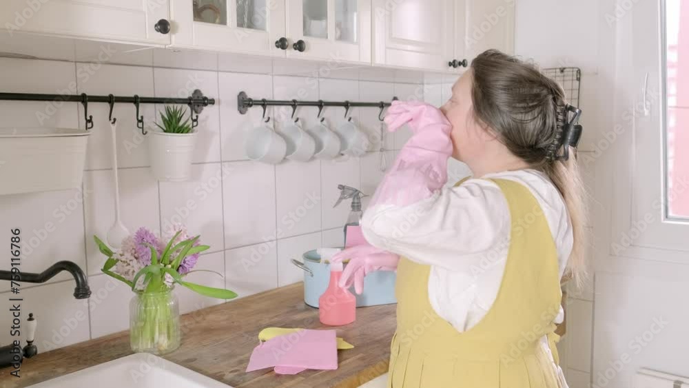woman in yellow apron diligently cleans spotless white kitchen, spring ...
