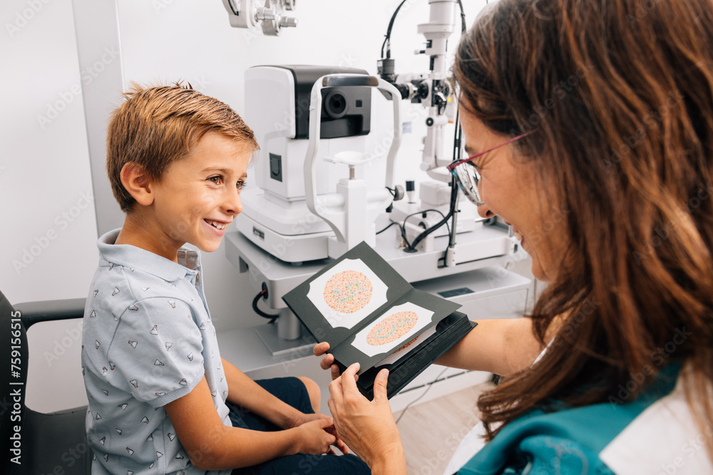 Optometrist doing color blindness test on boy Stock Photo | Adobe Stock