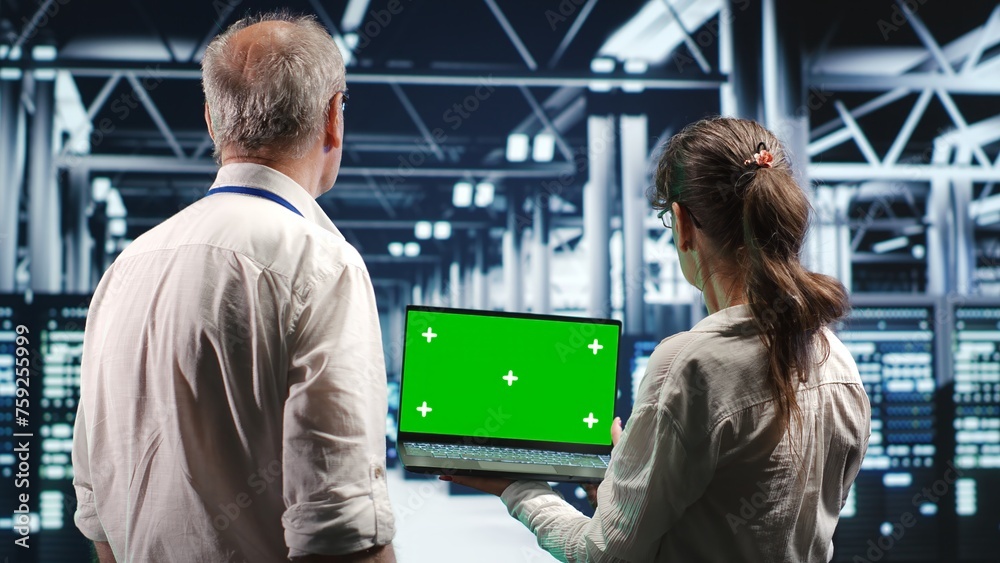 Coworkers in server room expertly managing data while navigating ... Coworkers in server room expertly managing data while navigating ...