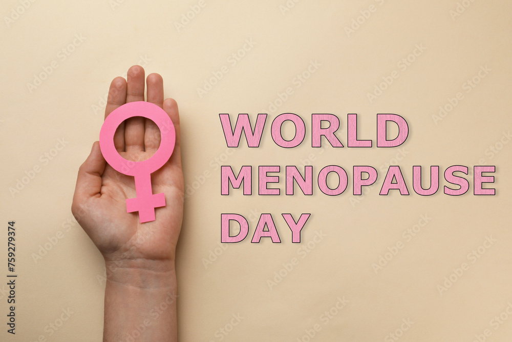 World Menopause Day. Woman holding female gender sign on beige ...