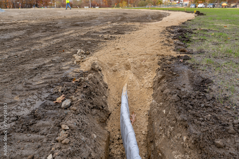 Construction photo of natural turf athletic field vertical edge drain ...