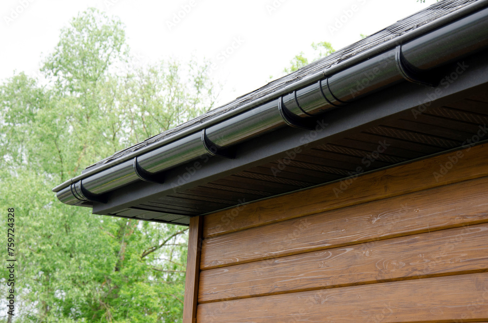 Gray plastic gutter system on roof overhang close up Stock Photo ...
