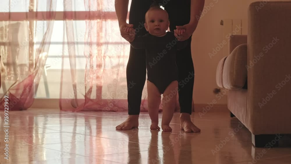 Cute baby trying to walk for the first time. Adorable infant holding ...