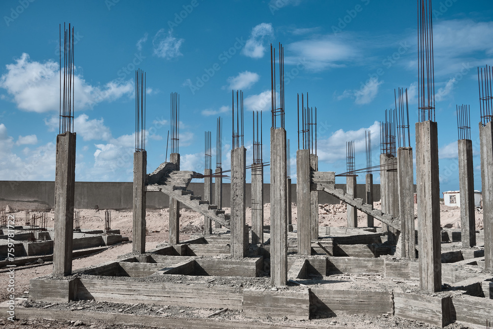 Reinforced concrete frame at construction site. Concrete pillars and ...