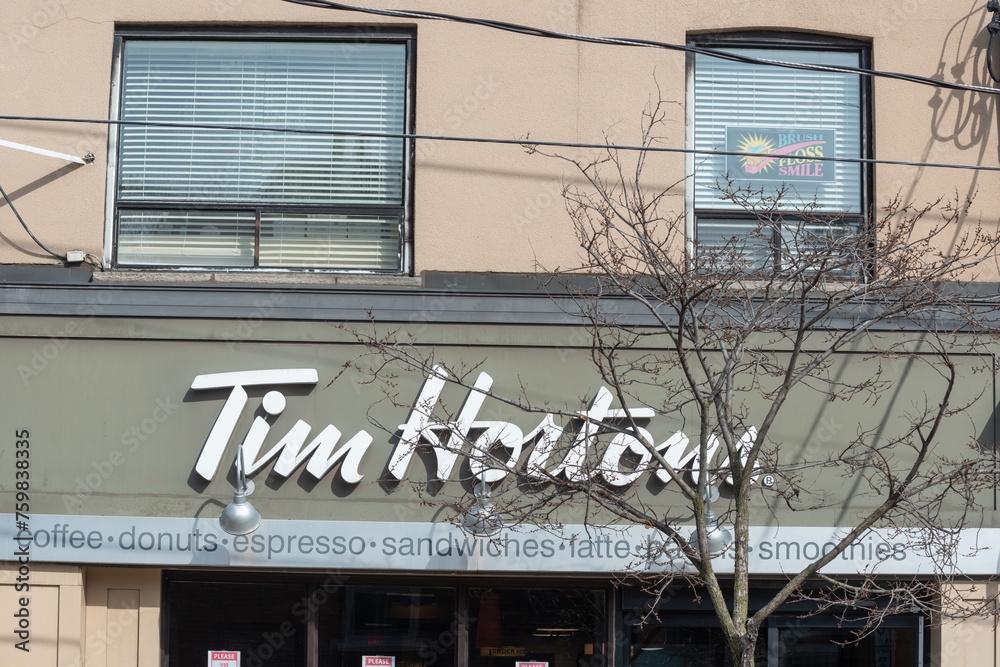 exterior building facade and sign of Tim Hortons, a chain coffee and ...
