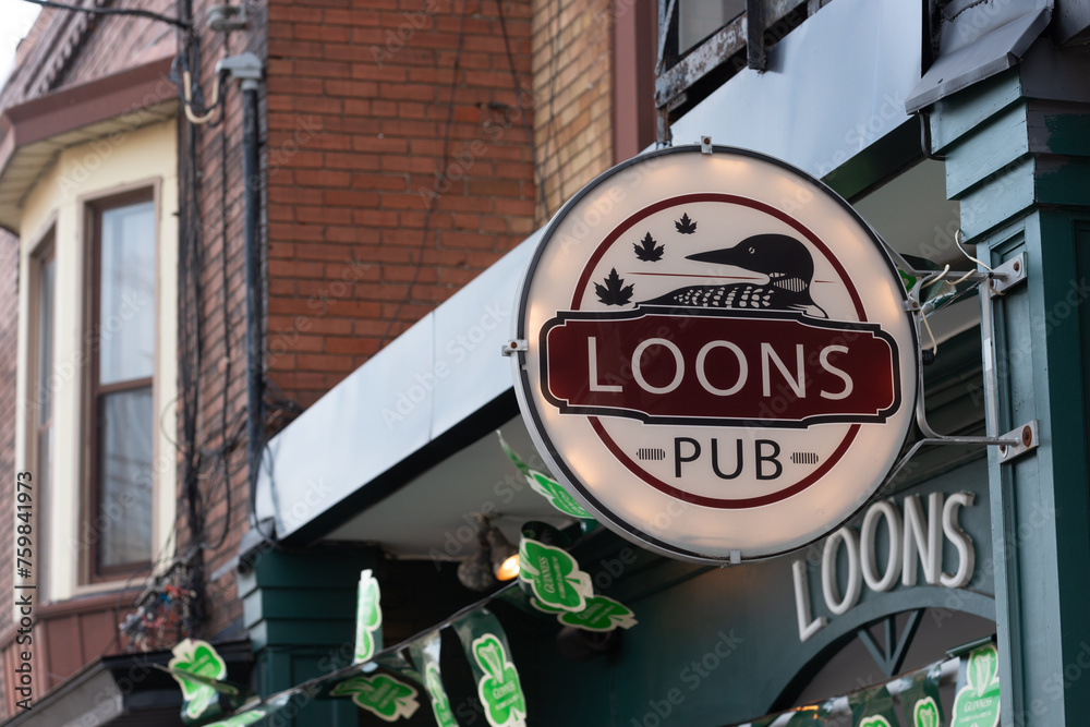 exterior building and round light sign of Loons, a pub, located at 416 ...