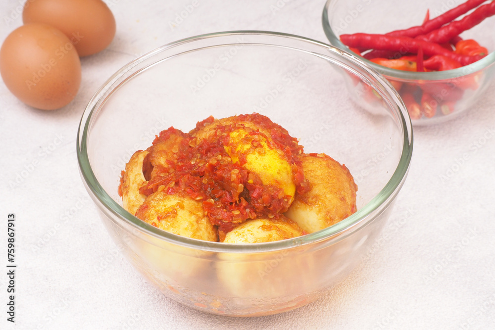 Telur bumbu balado or spicy boiled egg in a glass bowl. traditional ...