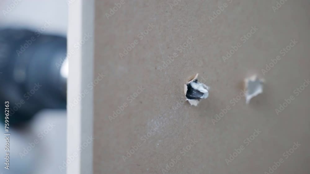 Electric screwdriver with metal bit drilling hole in drywall for ...