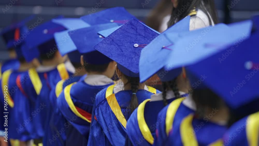 A group of women in black gowns and mortarboard hats holding diplomas ...