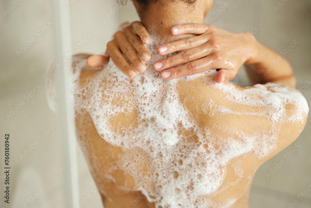 She hand gestures soap onto her back, cleansing every curve with care ...