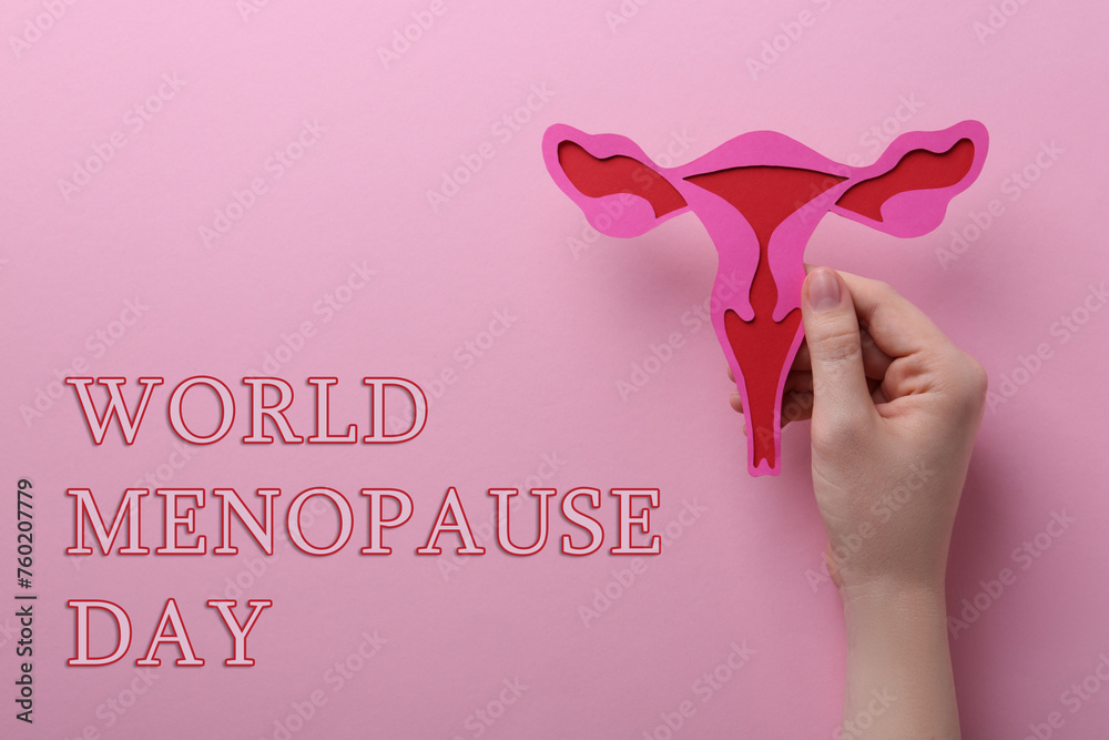 World Menopause Day. Woman holding paper uterus on pink background, top ...