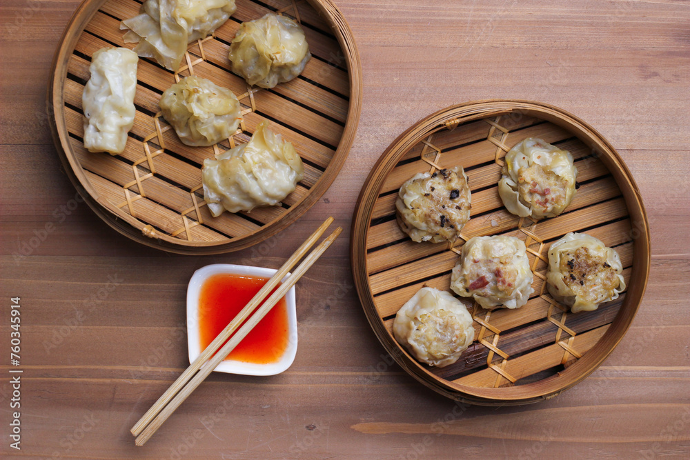 Various Dim Sum in Bamboo Steamed container served with tomato sauce ...